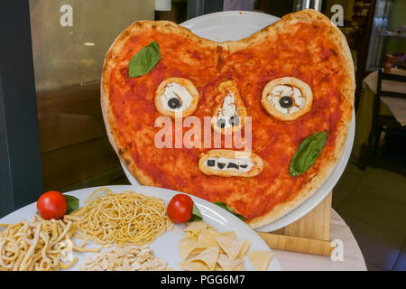 face shape pizza Stock Photo - Alamy