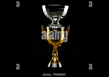 golden and silvered shiny trophy on black background Stock Photo - Alamy