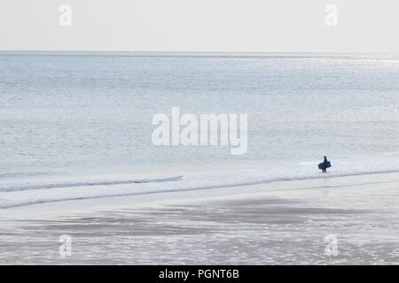 A female with a paddle board at Reighton Gap on the Yorkshire Coastline ...