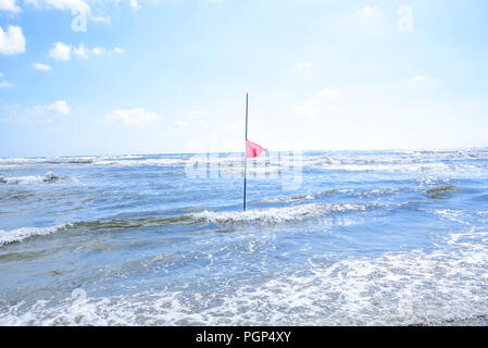 Rough sea. Bathing danger red flag Stock Photo - Alamy