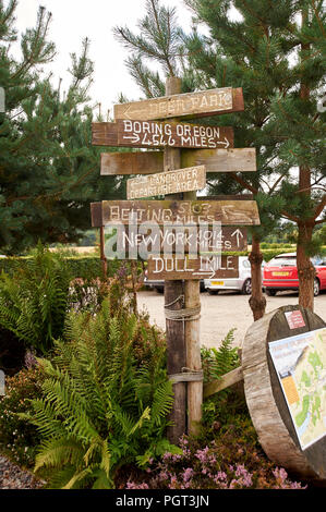 A colorful Crossroad signpost showing direction Stock Photo - Alamy