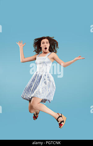 Freedom in moving. Surprised, pretty, happy young woman jumping and ...