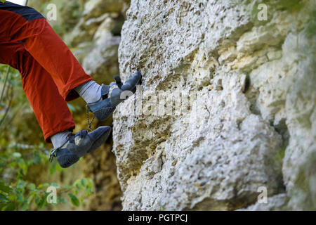 Photo of man's feet scrambling over rock up Stock Photo - Alamy