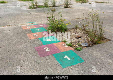 A hopscotch game in an old school playground with most of the numbers ...