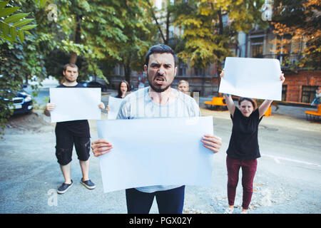 A group of people with posters demonstrate protest. The struggle for ...