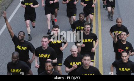 U.S. Air Force soldiers shout responses to commands while participating ...