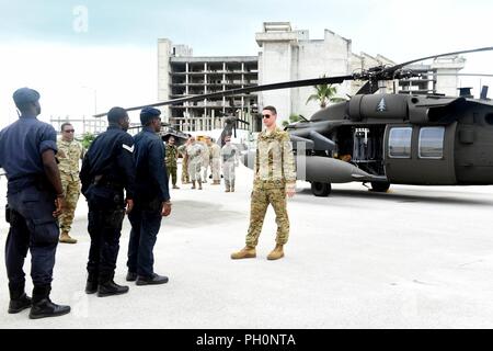SWAT team members armed with service rifles, standing in stack ...