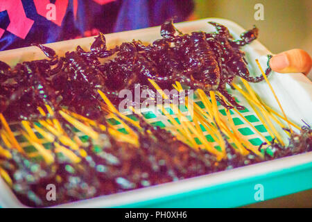 Cooked or Fried Centipede on a stick as sold at Donghuamen Night market ...