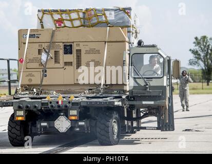 A Tunner 60K Aircraft Cargo Loader loads ammunition onto a C-17 at ...