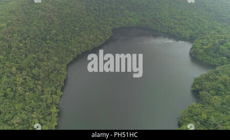 Aerial view of lake Bulusan in the mountains with green rain forest ...