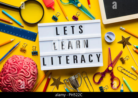 Lets learn to read lightbox message on a bright yellow background Stock ...