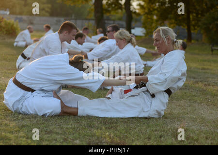 karatekas do relaxing massage after training Stock Photo - Alamy