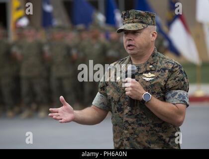 U.S. Navy Capt. Michael O. Enriquez, left, commanding officer, Field ...
