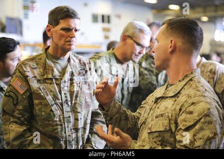 U.S. Marine Corps Capt. Daniel Tolbert, left, speaks with Capt. Tyler ...