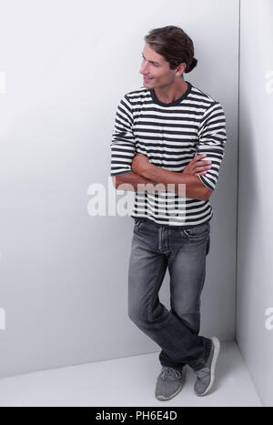 modern man standing in the corner of the white room Stock Photo - Alamy