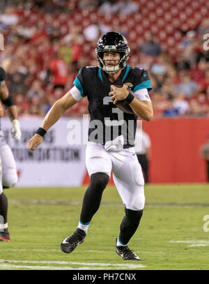 Jacksonville Jaguars quarterback Tanner Lee, center, runs through an ...