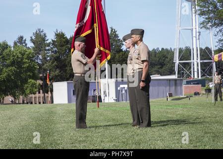 U.S. Marine Corps Maj. Scott Caton accepts a plaque on behalf of Capt ...
