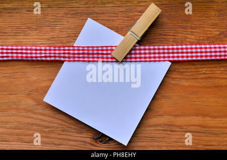 red checkered bow on wood background Stock Photo - Alamy
