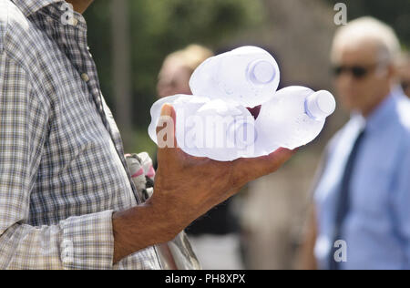 Indian man selling plastic water pots to women in a rural indian ...