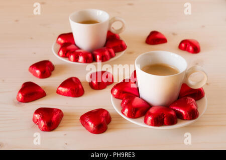 Coffee beans, chocolate and red hearts on a natural wooden background ...