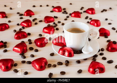 Coffee beans, chocolate and red hearts on a natural wooden background ...