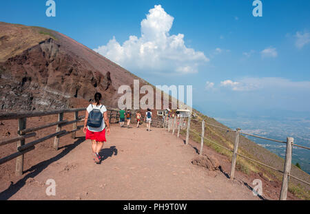 MOUNT VESUVIUS, ITALY - AUGUST 1, 2018: Tourists walk around the crater ...