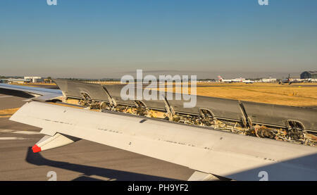 Jet plane air brakes and flaps fully extended after landing. Hydraulic ...