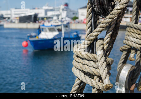 detail of the rigging of an old sailing ship, a wooden triple deadeye ...