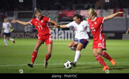 Wales' Elise Hughes (centre) battles for the ball with Germany's Sara ...