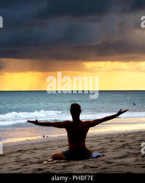 The young man doing yoga in bedroom Stock Photo - Alamy
