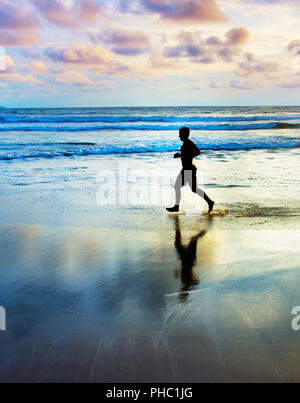 men jogging on the beach Stock Photo - Alamy