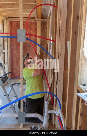 Plumber working with plastic pipes Stock Photo - Alamy