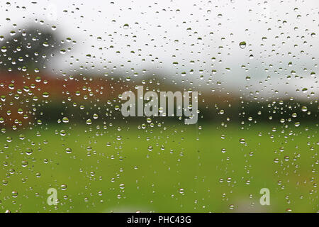 Raindrops on the window pane. Blurred background outside the window in the rain Stock Photo - Alamy