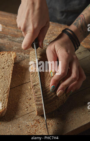 Female hands cut freshly baked bread Stock Photo - Alamy
