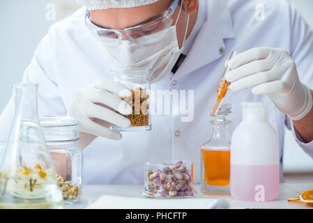 Chemist mixing perfumes in the lab Stock Photo - Alamy