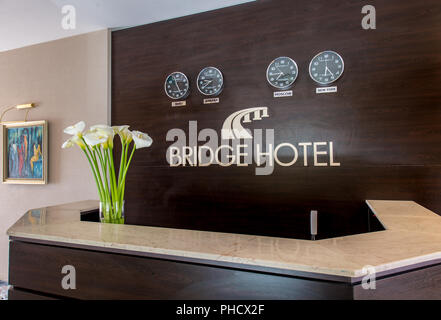 Hotel reception with desk and clocks Stock Photo - Alamy