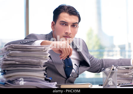 Busy angry businessman with heaps of paper Stock Photo - Alamy