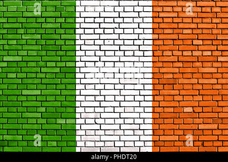 The national flag of Ireland painted on a wall of sibit blocks with ...