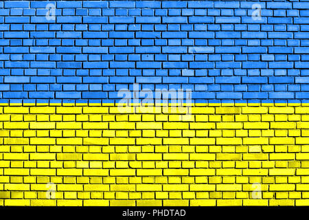 Flag of Ukraine on brick wall background on town street. Exterior old ...