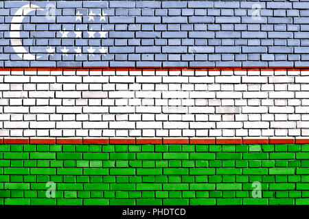 Uzbekistan national flag painted on textured wall mural background ...