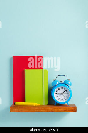 notepad and book on shelf at wall background surface Stock Photo - Alamy