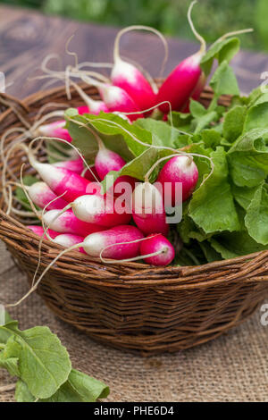 Bunch of radishes with leaves on a wicker table Stock Photo - Alamy