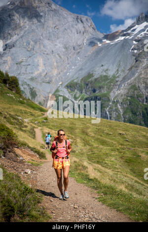 Pretty, female hiker/climber in a lovely alpine setting of Swiss Alps ...