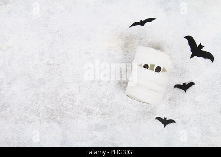 The concept for Halloween. Bats and mummy from a jar, bandages and ...