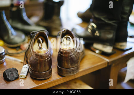 interior repair shop and shoe making, shoemaker workbench with shoes in ...