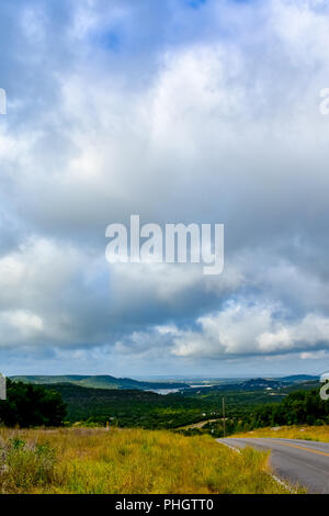 Lake Travis, Texas USA: Two teen girls practice turning over a capsized ...