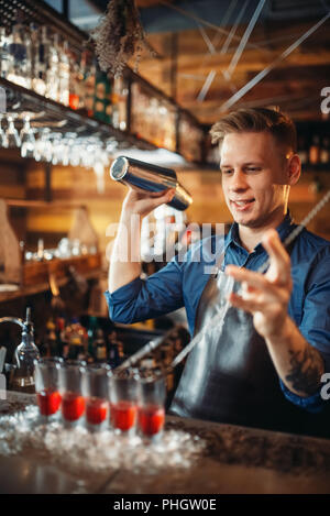 Male bartender prepares alcoholic coctail with ice. Barkeeper ...