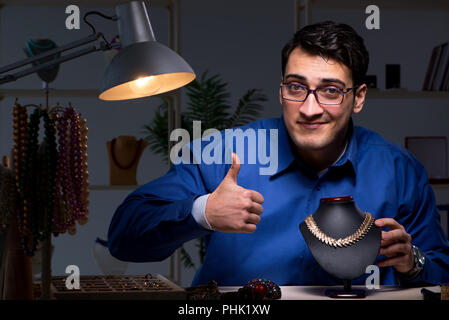 Jeweler working in his workshop late at night Stock Photo - Alamy