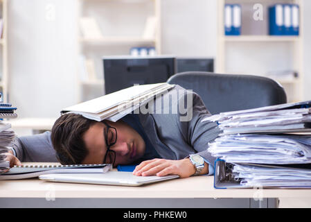 Overloaded with work employee under paperwork burden Stock Photo - Alamy