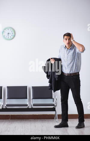 Man nervously impatiently waiting in the lobby Stock Photo - Alamy
